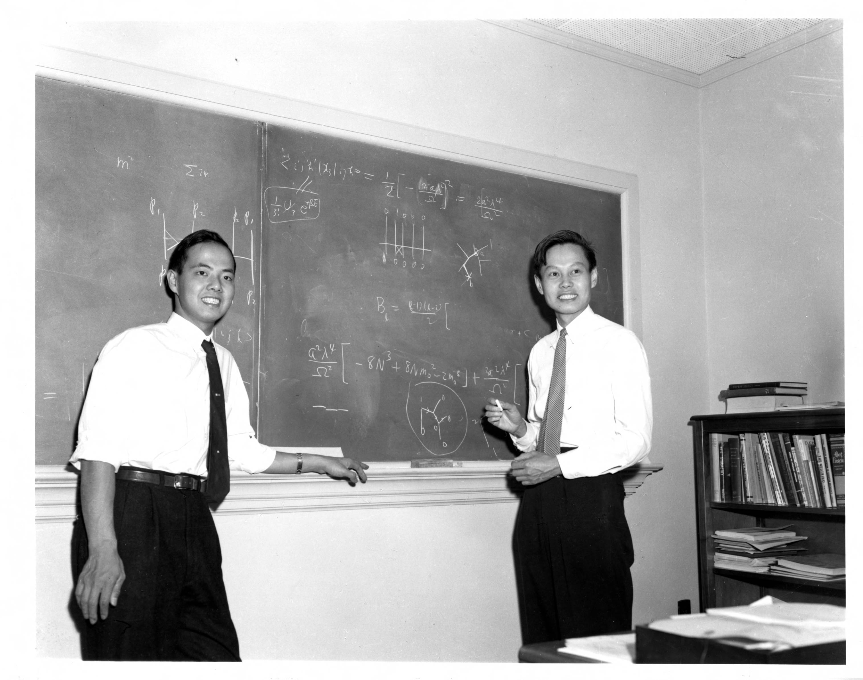 T.D. Lee (l.) and Chen Ning Yang at a blackboard in an Institute office